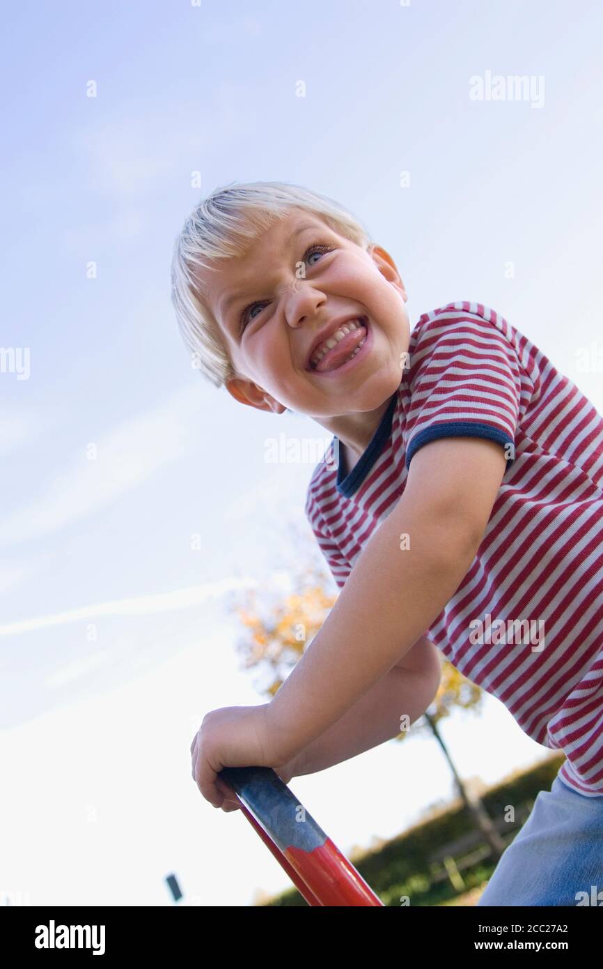 Little boy (4-5) playing on playground Stock Photo - Alamy