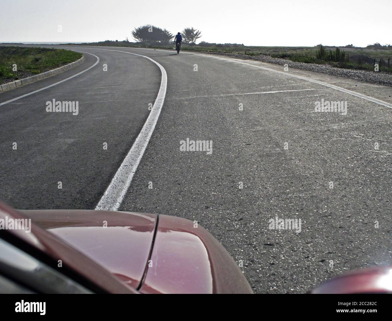 High angle shot of a red car driving on an empty road Stock Photo - Alamy