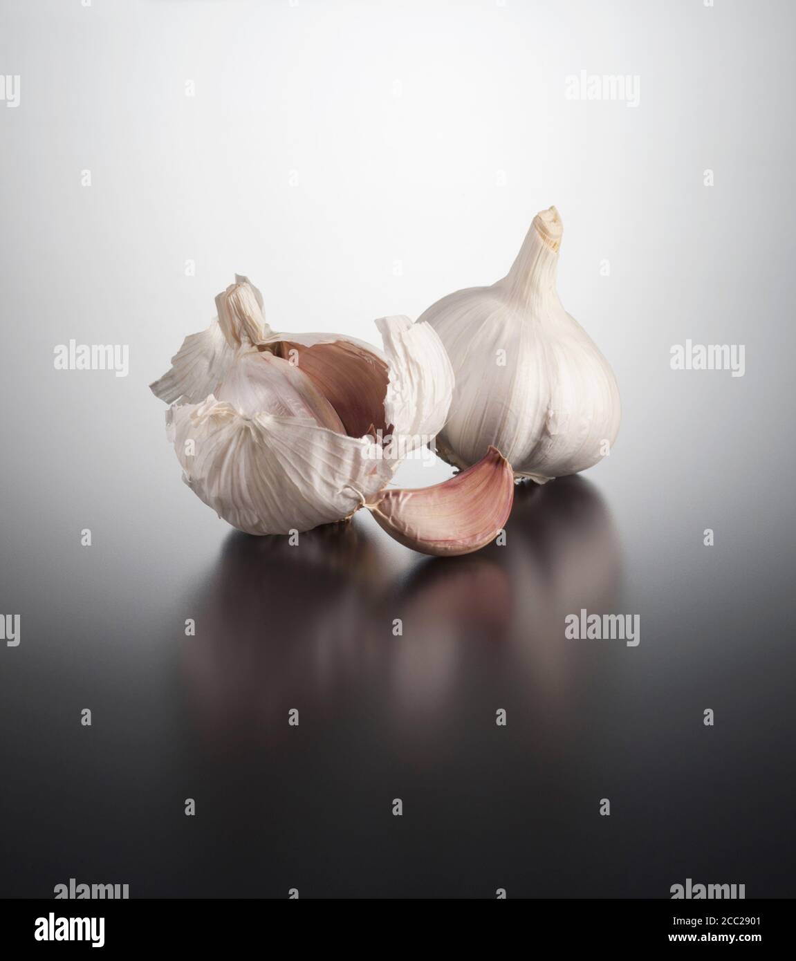 Garlic clove and garlic bulb on coloured background, close up Stock ...