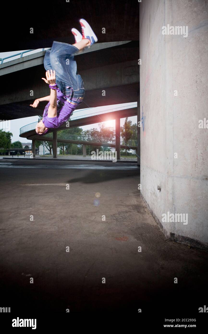 Germany, Cologne, Young man doing flip in the air, portrait Stock Photo ...