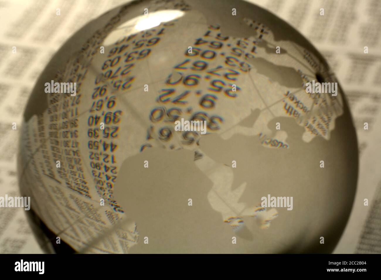Glass globe on newspaper hi-res stock photography and images - Alamy