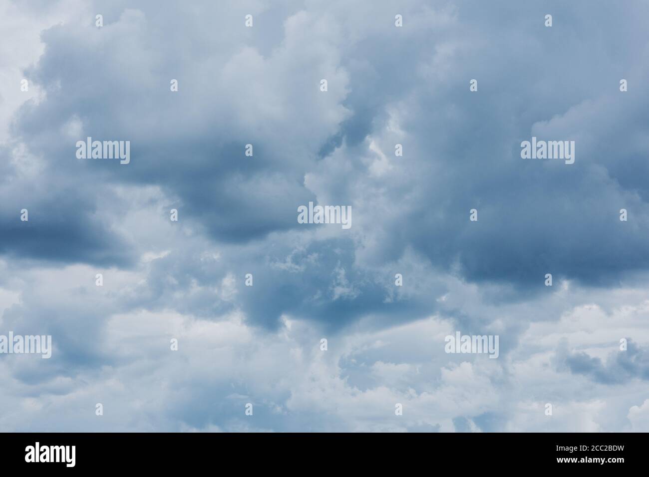 moody fluffy blue cloudscape in summer Stock Photo - Alamy