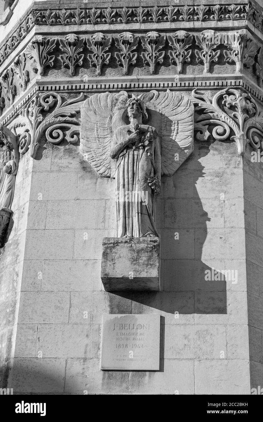 Vertical shot of an angel statue with wings in Basilica of Notre Dame ...
