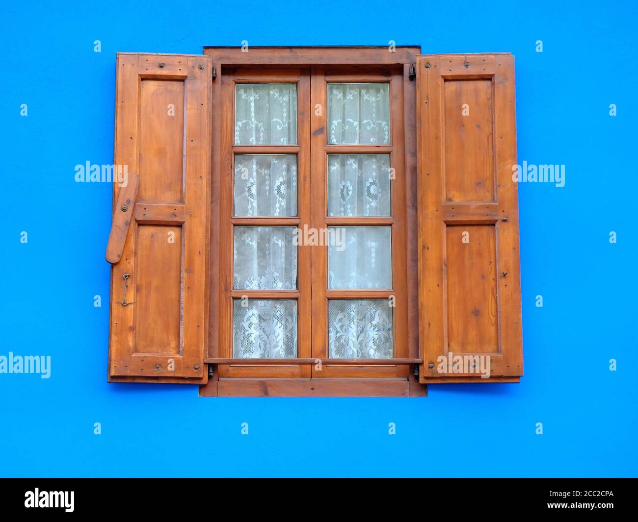 Windows, wooden frames, in brightly coloured walls Stock Photo - Alamy