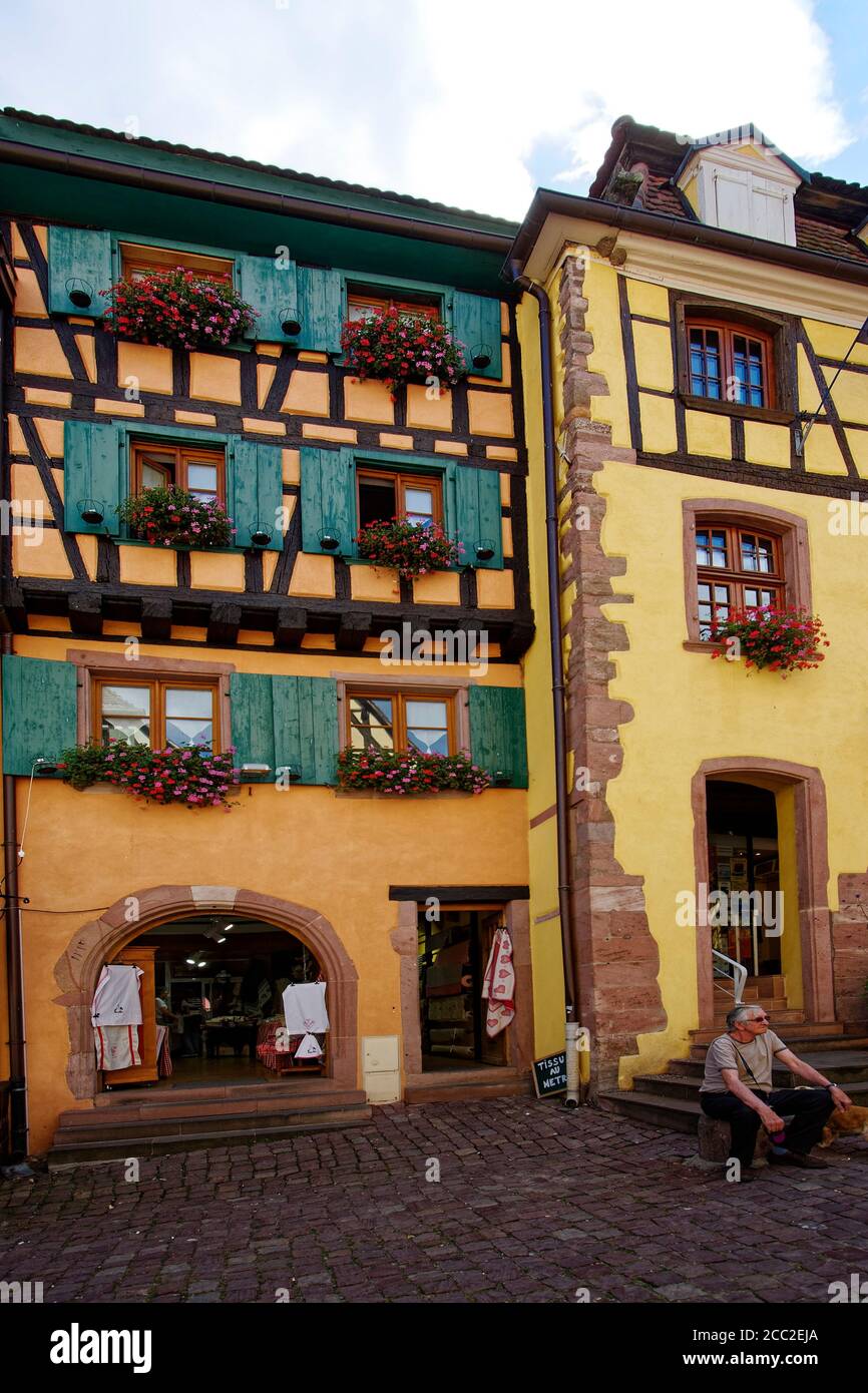 2 old buildings, half-timbered, colorful , flowers, green shutters ...