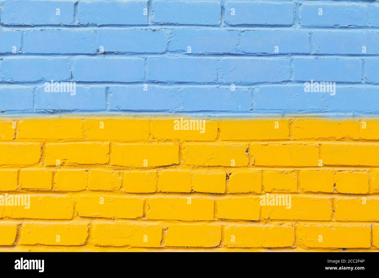 Painted brick wall in the colors of the Ukrainian flag Stock Photo - Alamy