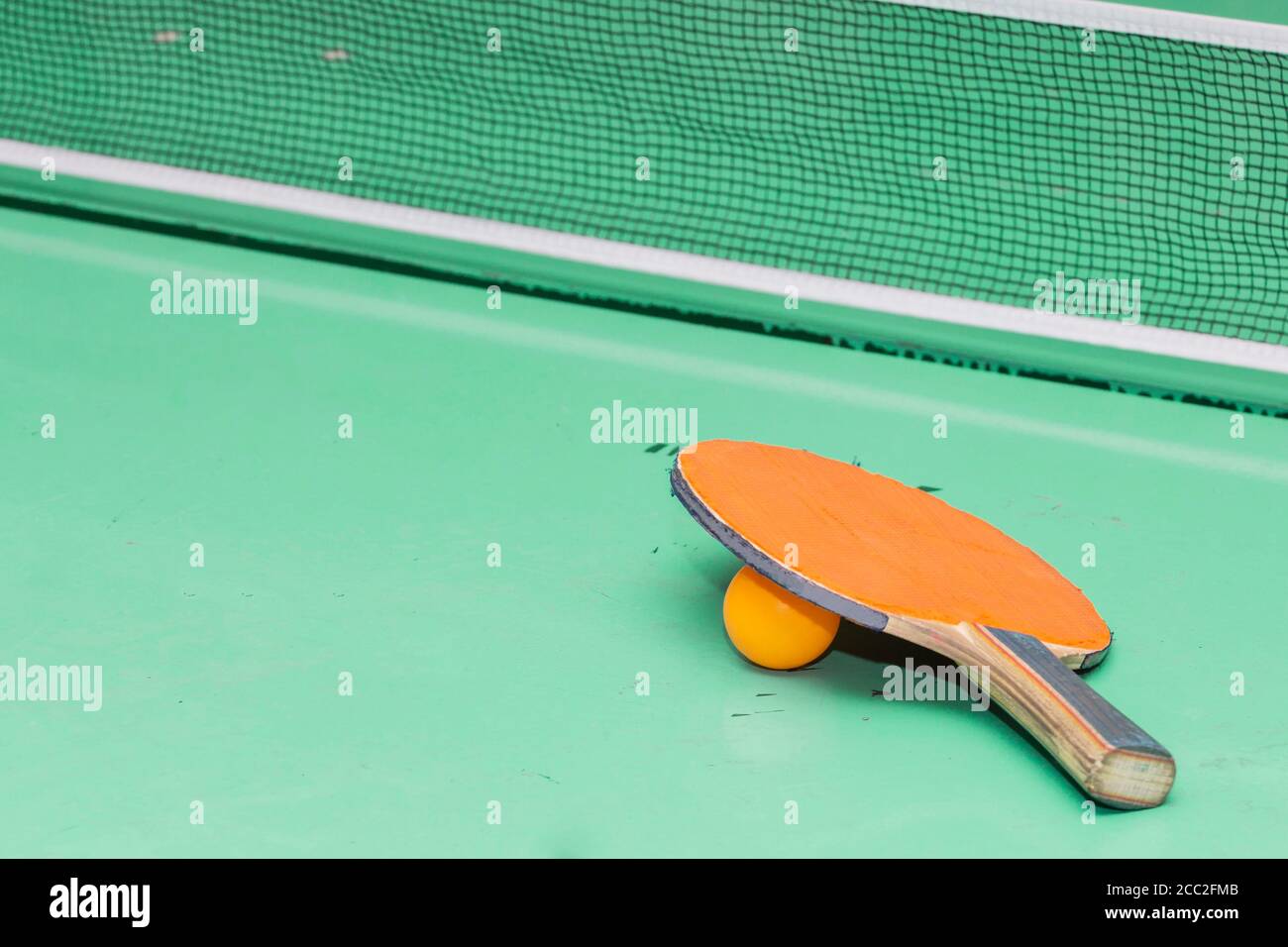 Old table tennis rackets on the game table Stock Photo - Alamy