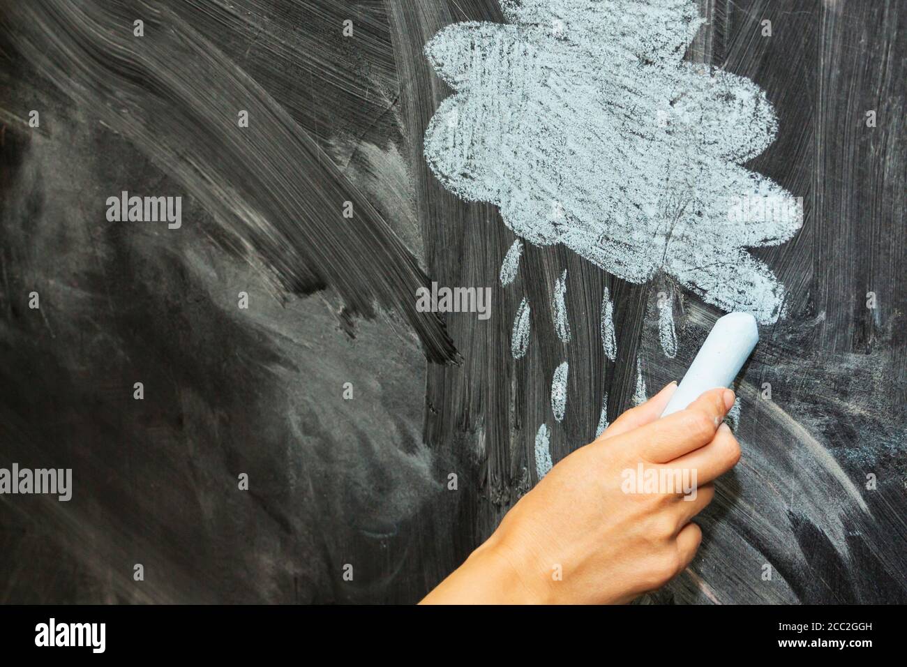 A cloud and a rain drawn with chalk on a blackboard Stock Photo - Alamy