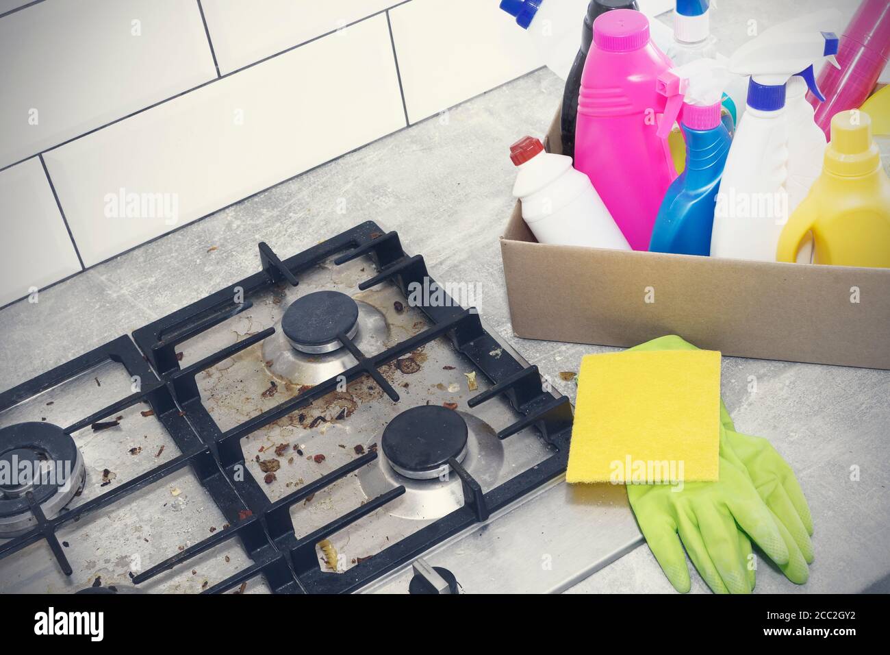 Cleaning a gas stove with kitchen utensils, household concepts, or ...