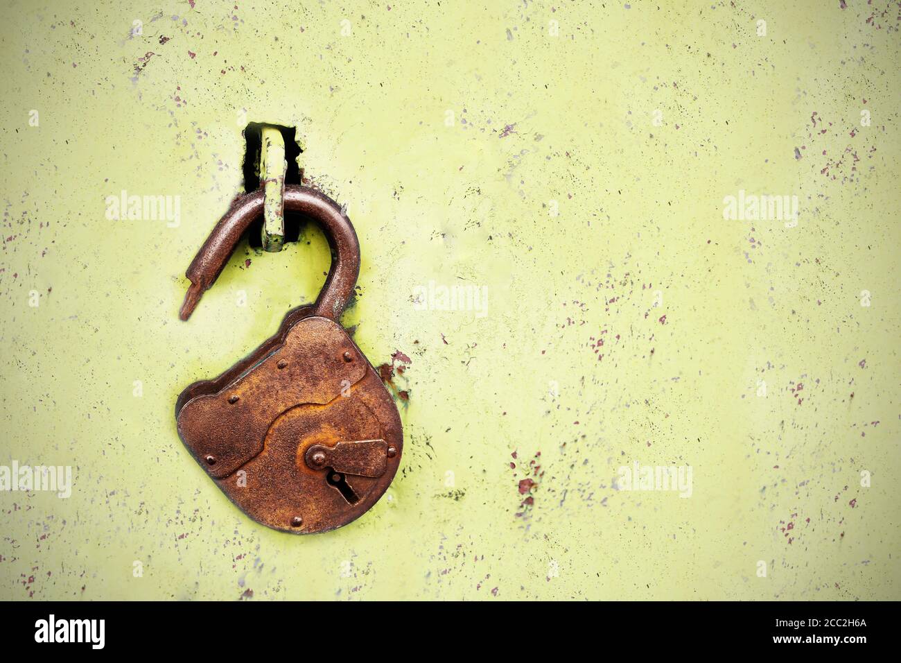 Old rusty lock without a key on a blue background Stock Photo - Alamy