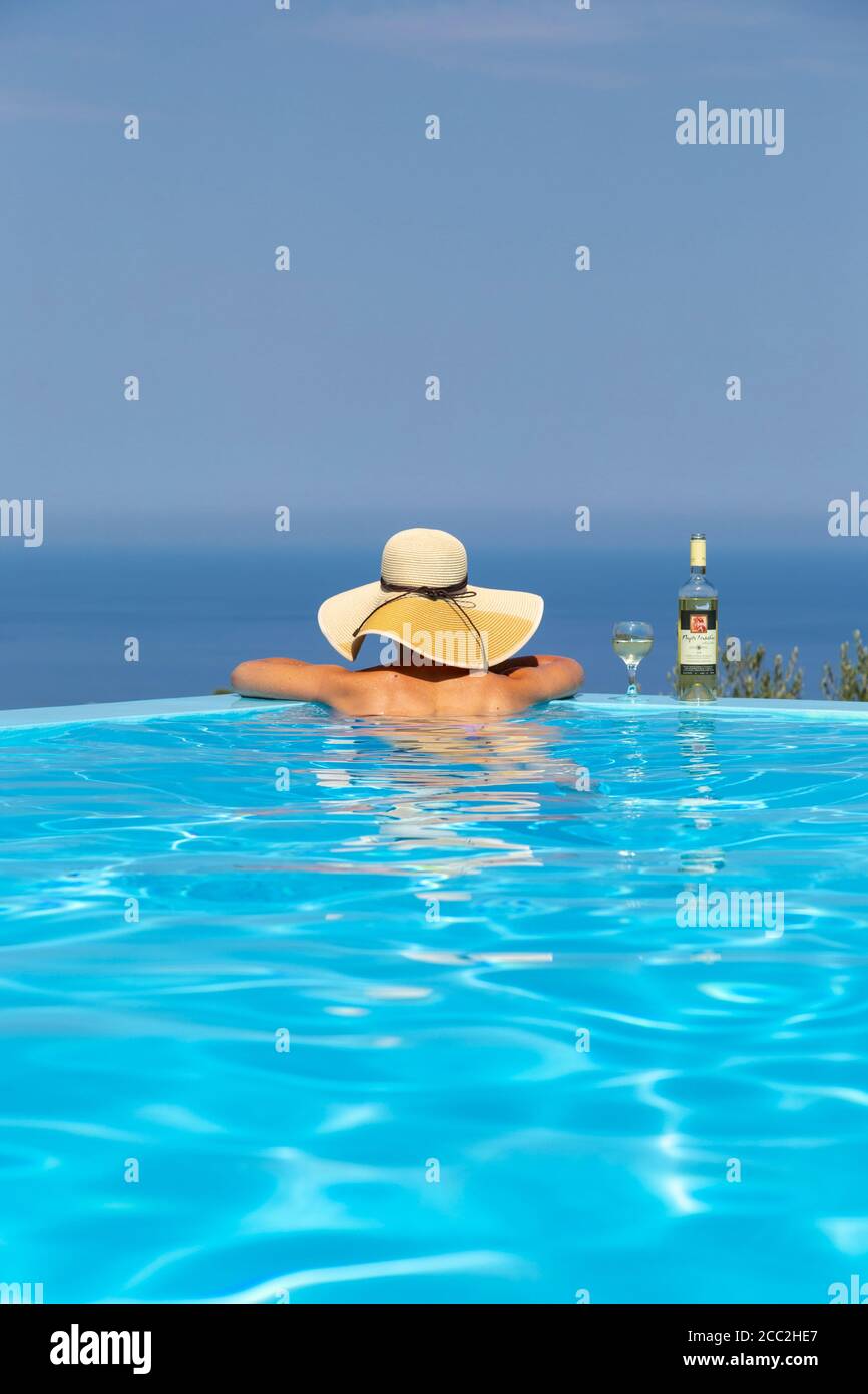 Woman Leaning At The Edge Of Swimming Pool High Resolution Stock ...