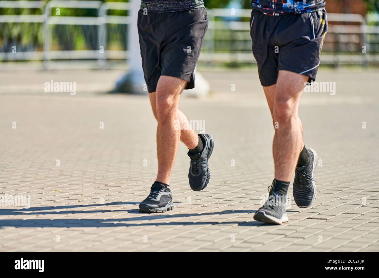 Running men. Sport men jogging in sportswear on city road. Healthy ...