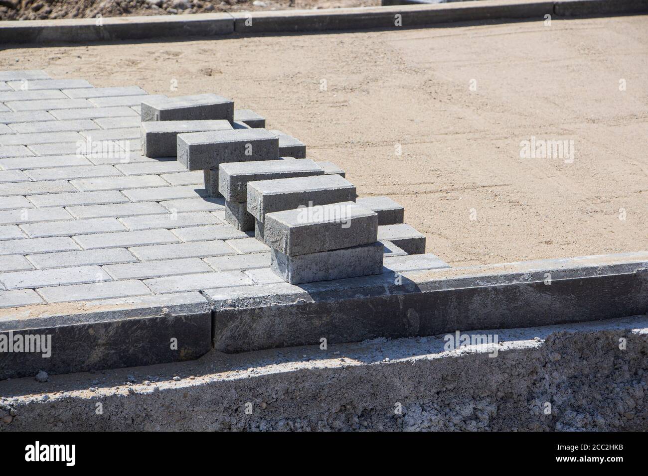 Process of construction of brick paved sidewalk, half built pavement ...