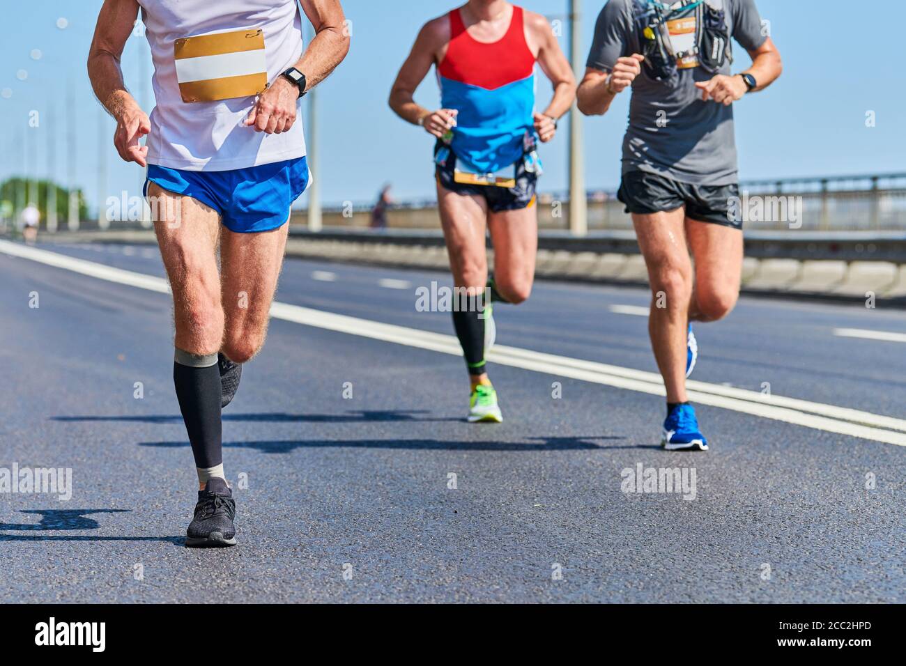 Marathon runners on city road. Running competition. Street sprinting ...