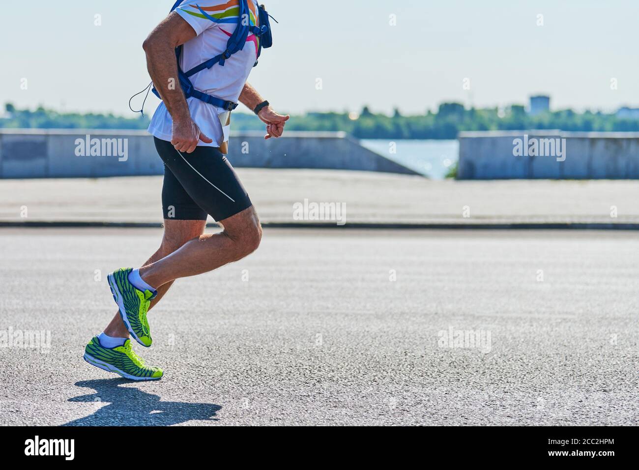 Running man. Athletic man jogging in sportswear on city road. Healthy ...