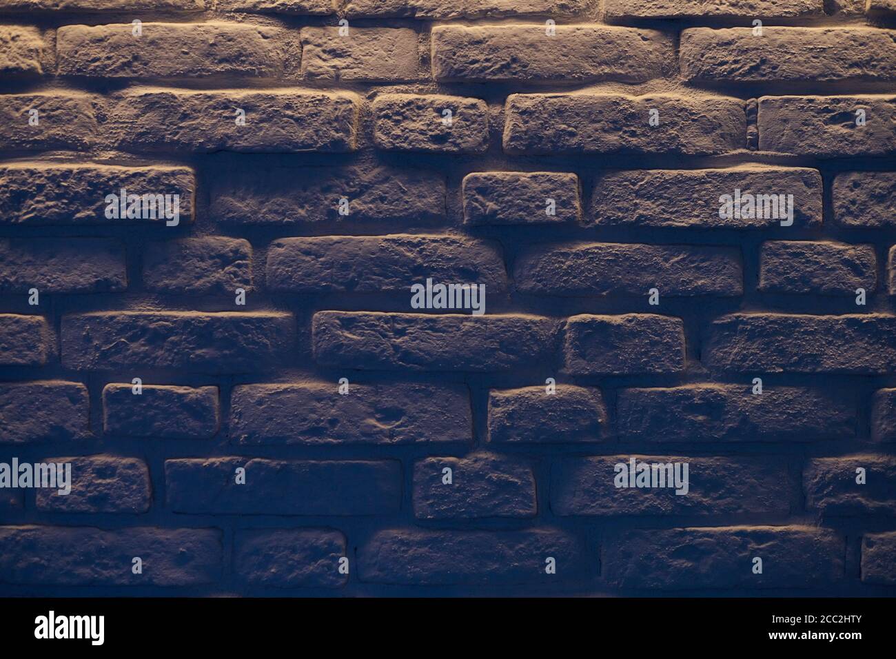 Brick wall indigo lighting. White wall blue glow in modern vintage loft ...