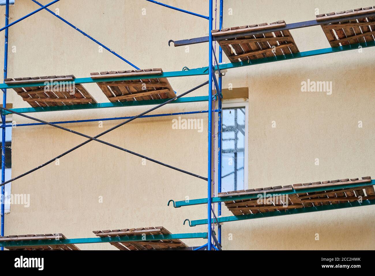 Scaffolding on construction site. Incomplete building and decoration ...