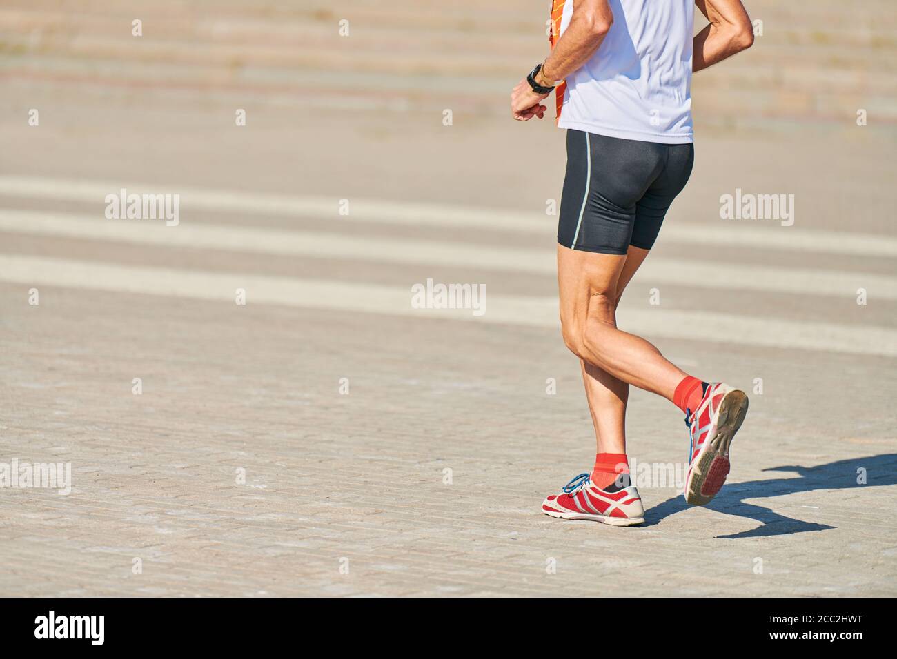Running man. Athletic man jogging in sportswear on city road. Healthy lifestyle, fitness sport ...