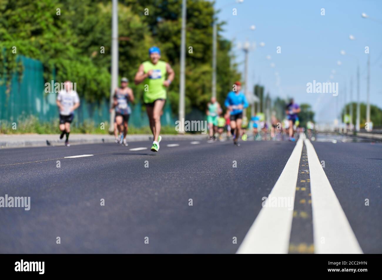 Runners on city road. Running marathon, copy space. Street sprinting ...