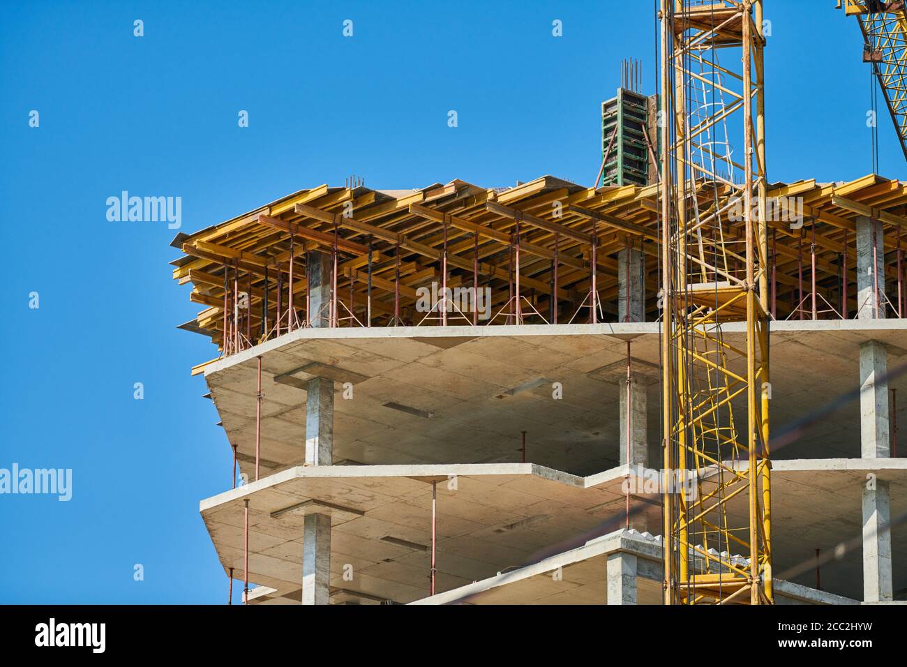 Scaffolding on construction site. Incomplete building and decoration ...