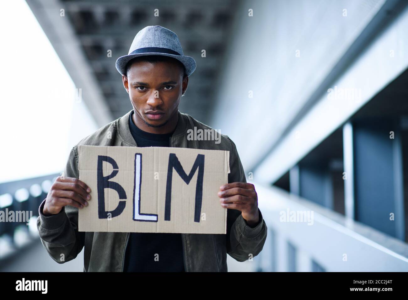 Man with BLM sign standing outdoors, black lives matter concept Stock ...