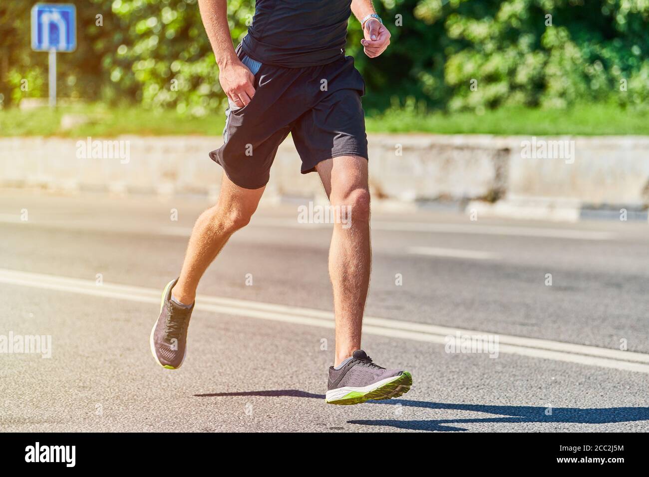 Running man. Athletic man jogging in sportswear on city road. Healthy lifestyle, fitness sport ...