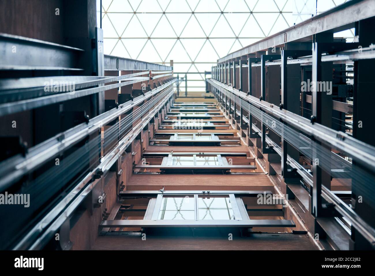 Open elevator lift shaft. Modern architecture with transparent ceiling ...