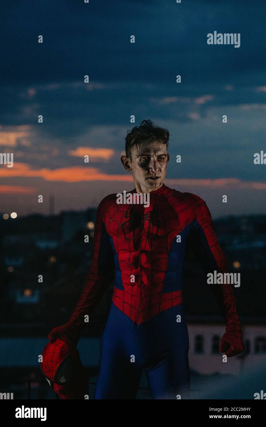 Cosplayer in image of a character Spider-Man stands on roof of house ...