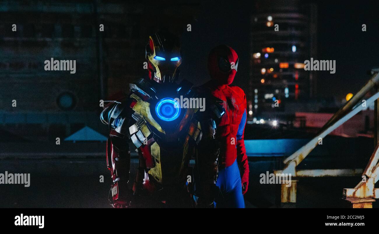 Two cosplayers stand together in images of a character Spider-Man and ...