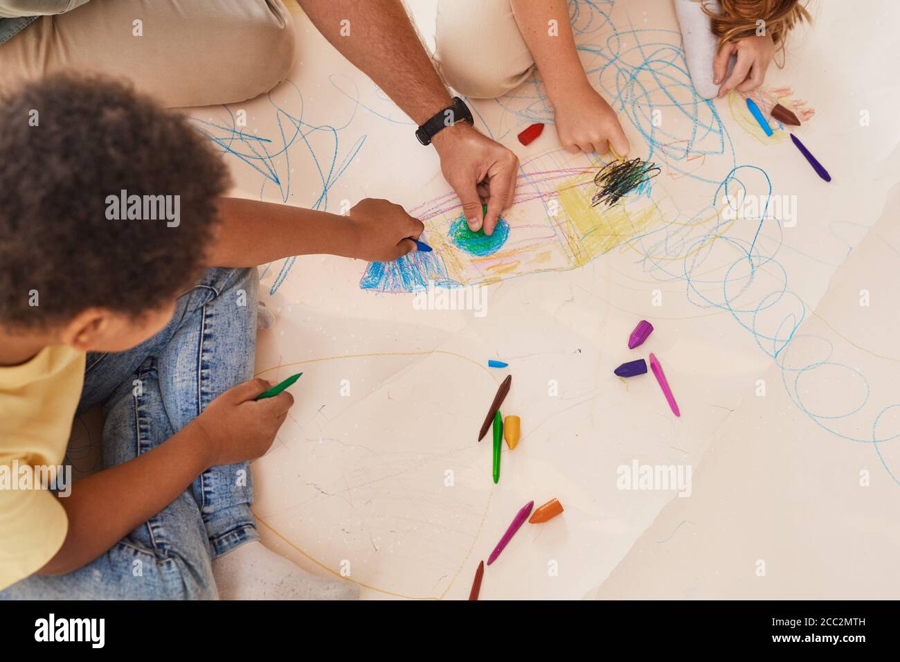 High angle closeup of unrecognizable male teacher working with kids ...