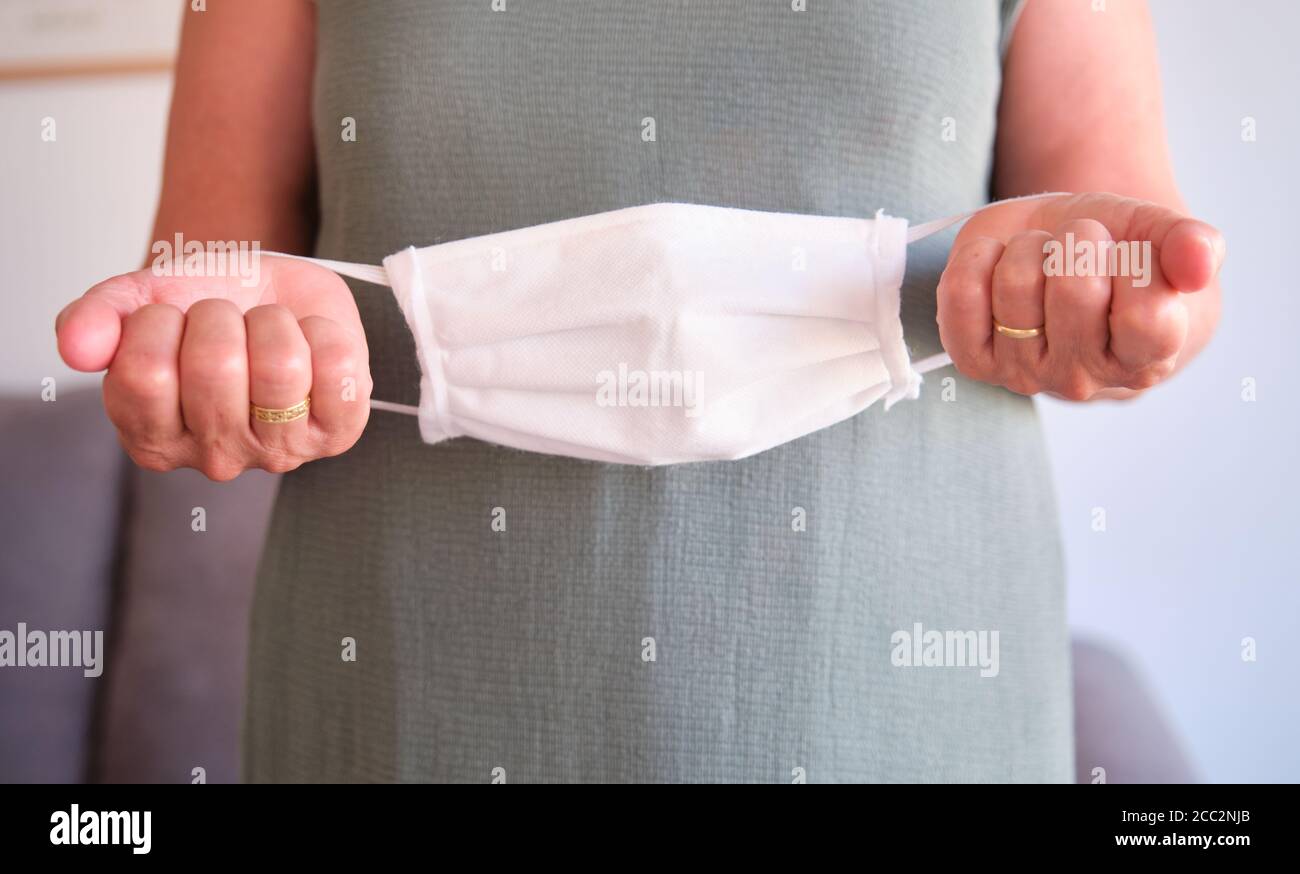 We are slaves of medical masks. Face masks as handcuffs concept Stock ...