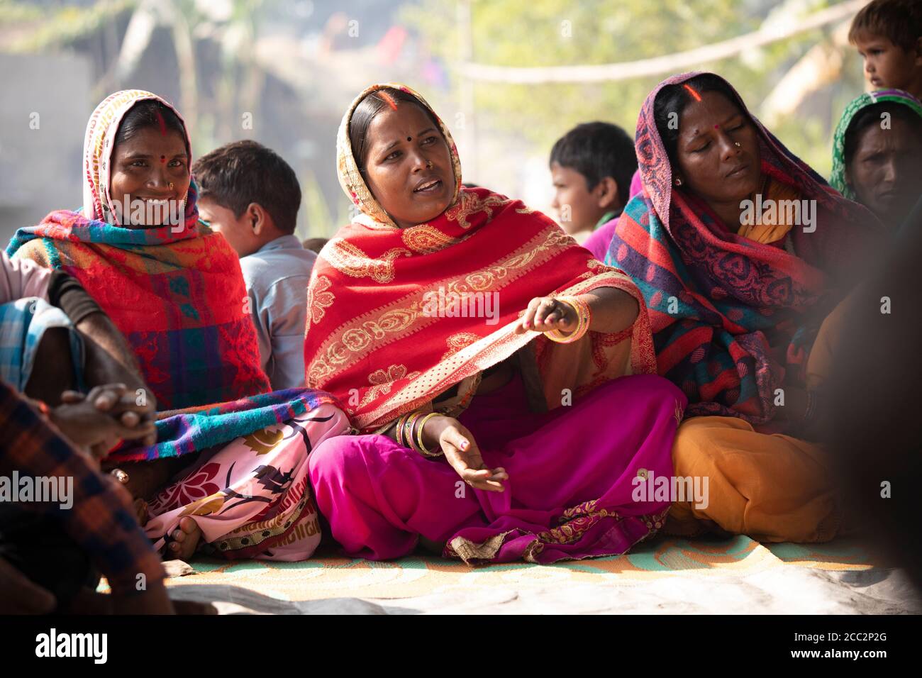 Women talking at a community meeting under a village tree in Bihar ...