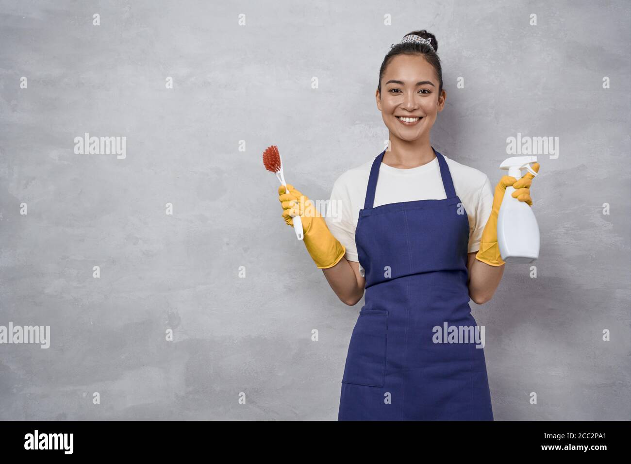 Housekeeping and housework concept. Portrait of a happy young woman ...