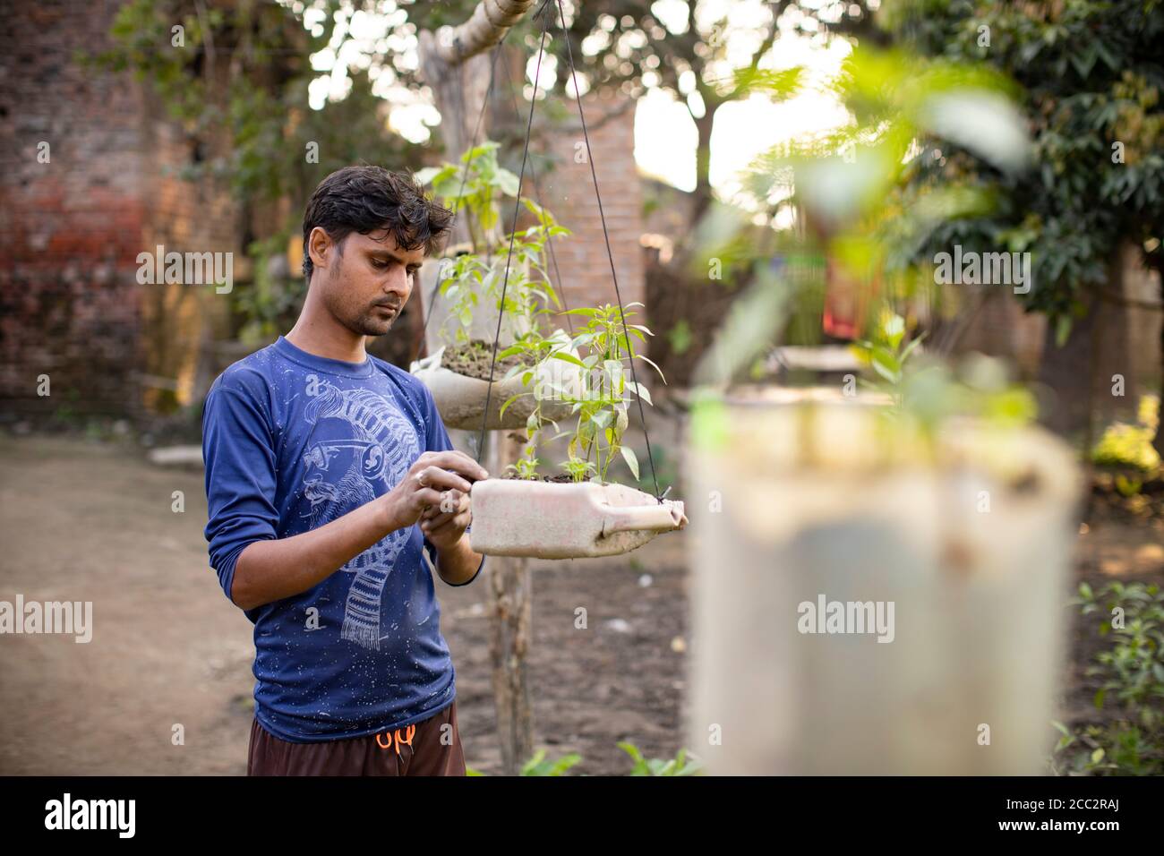 Prabhu Nath (26) cares for young seedlings in a hanging nursery on his ...