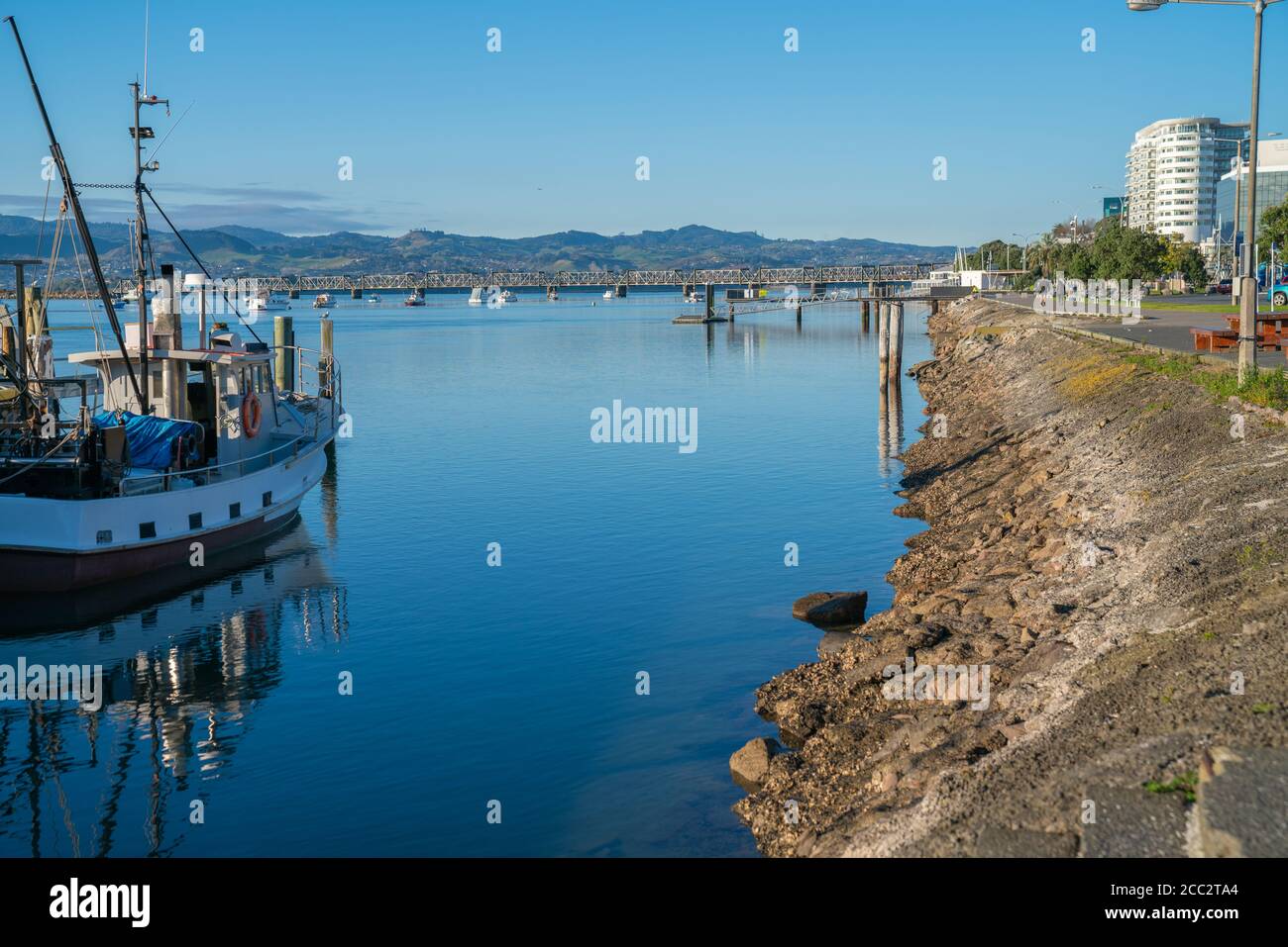 Tauranga downtown Strand waterfront from old wharf with fishing boat ...