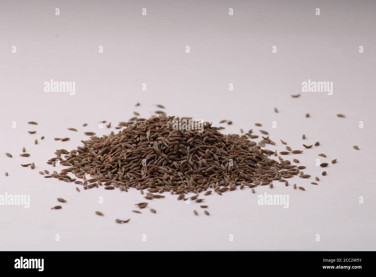 Pile of cumin seeds isolated on white background Stock Photo - Alamy