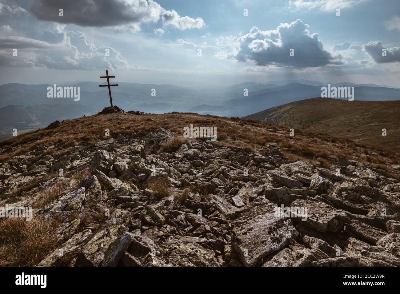 Patriarchal cross on the mountain summit with spectacular sun rays ...