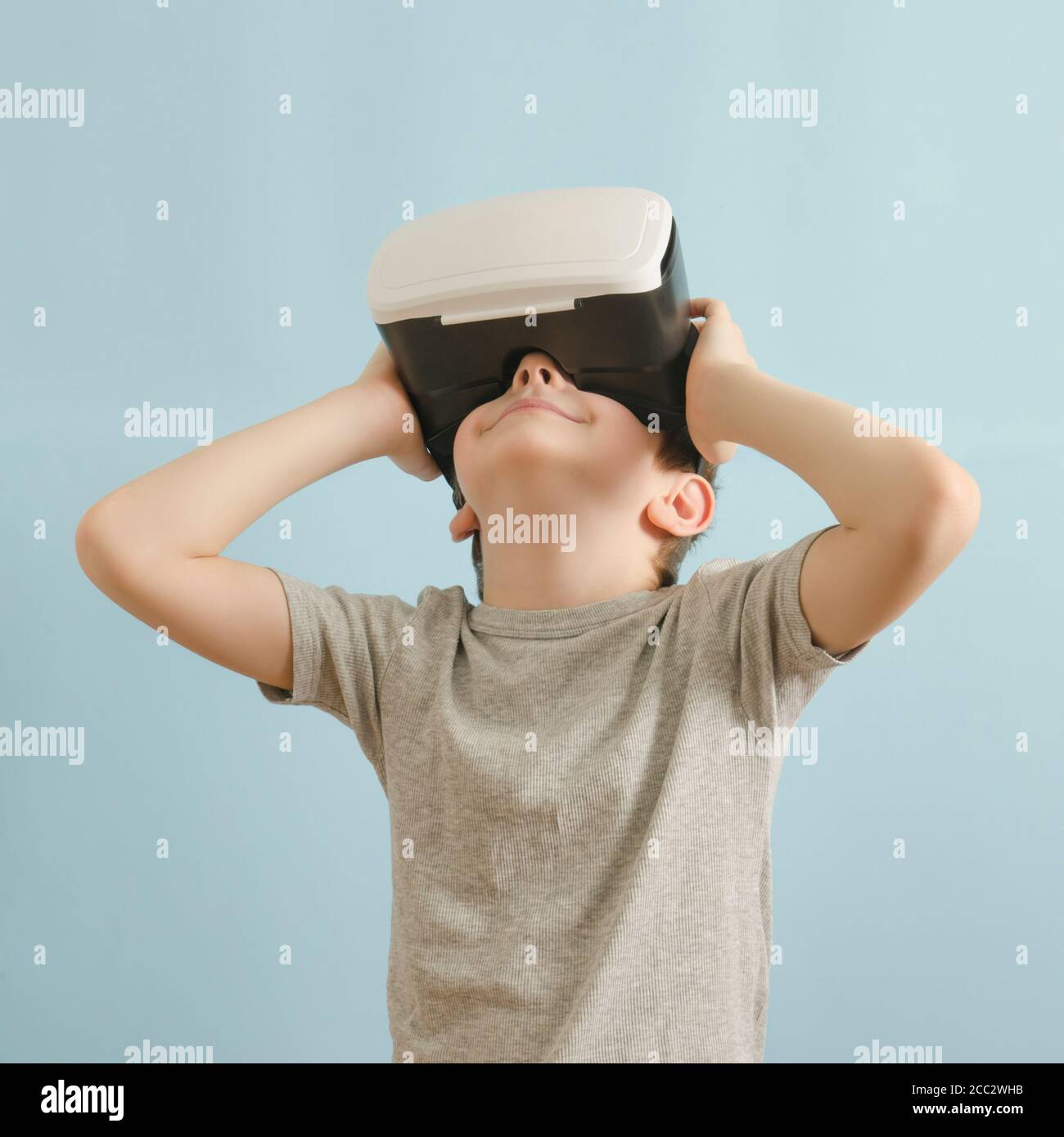 Smile boy with glasses of virtual reality. Blue background Stock Photo ...