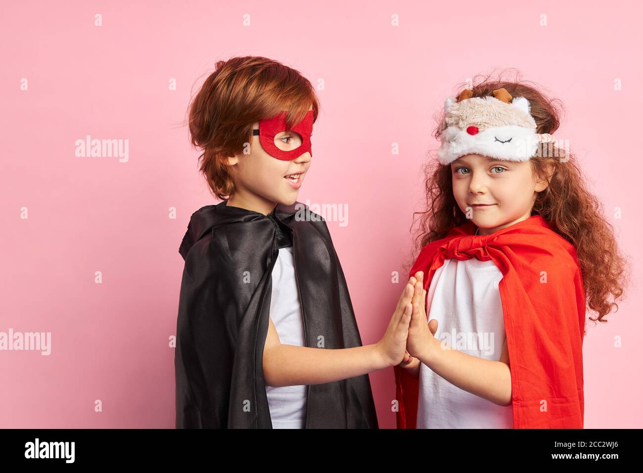 Attractive caucasian girl and boy clap hands, girl look at camera ...