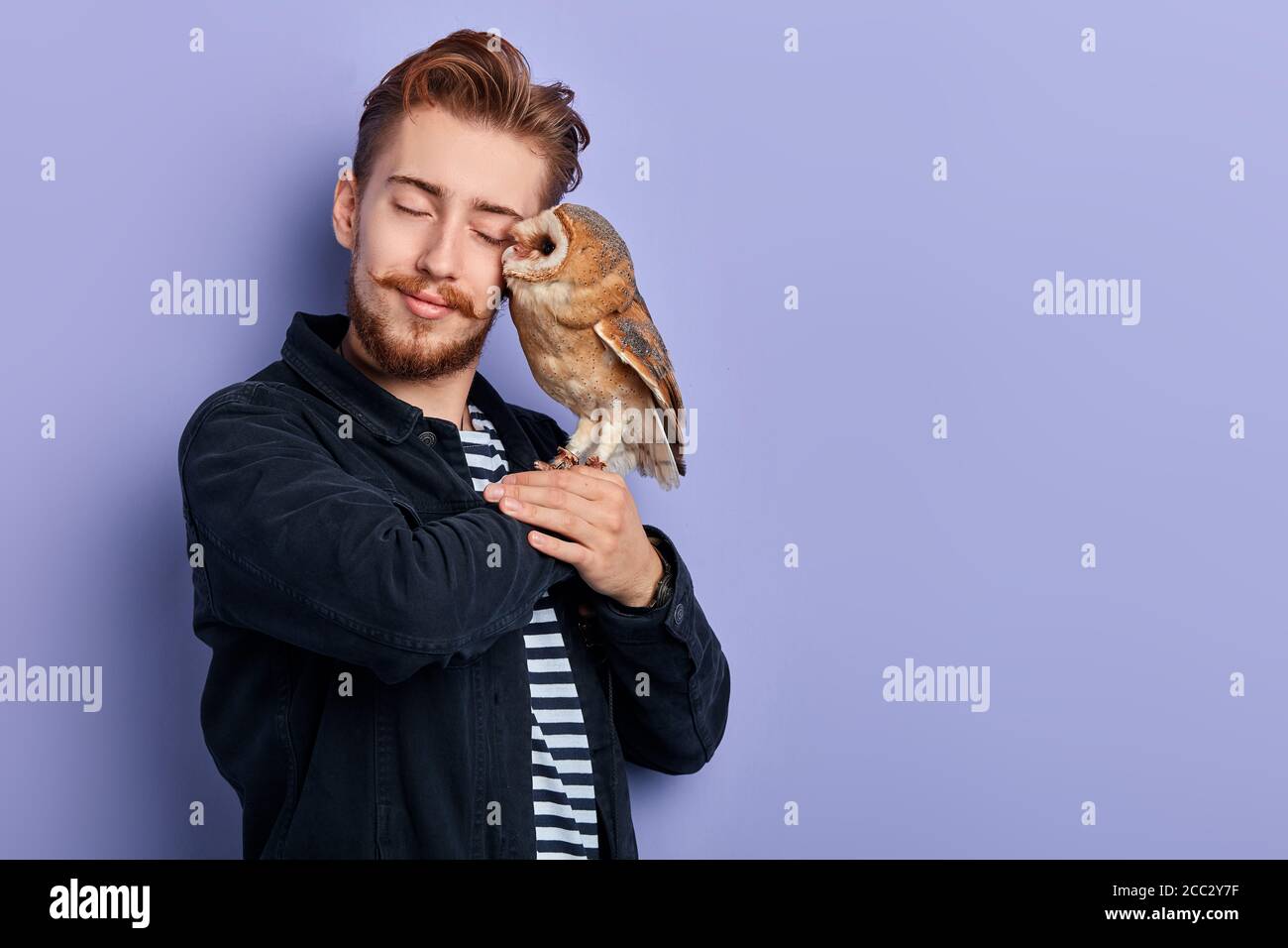 pleasant happy young man leaning on his owl. emotions , love at first ...