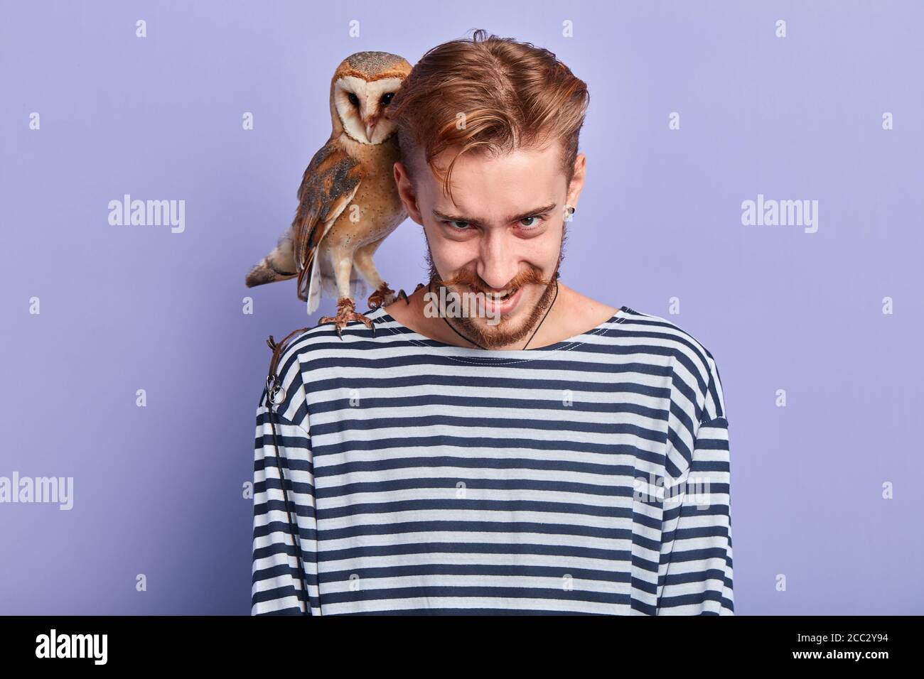 crazy angry guy frowning his eyebrows and looking at the camera, young ...