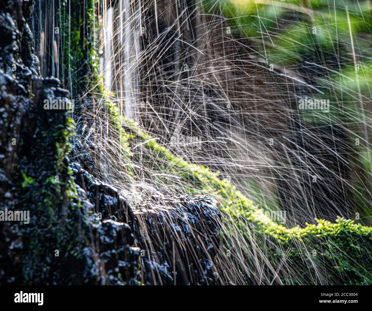 Water drops jumping from rock. Small waterfall, close up view. Water ...