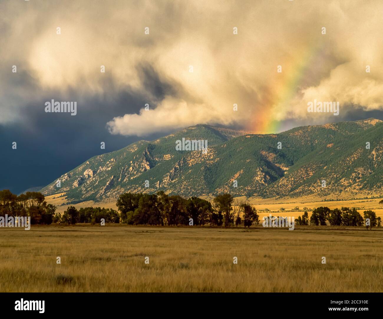 rainbow and storm clouds over the madison range near ennis, montana ...