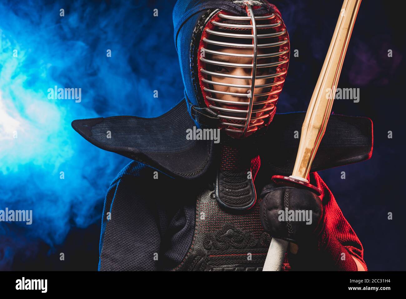 confident kendo fighter in armor practicing with bamboo sword ...