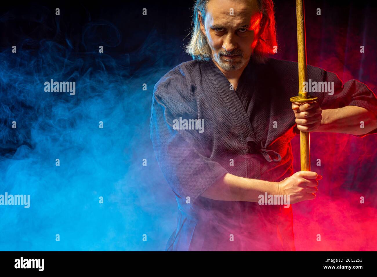 strong caucasian kendo fighter in traditional clothes. japanese martial ...