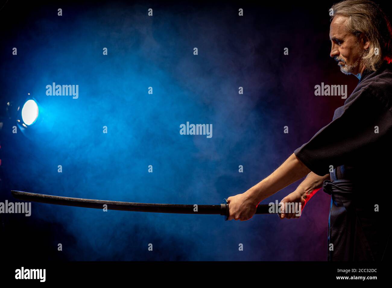 confident caucasian kendo warrior in traditional outfit use bamboo ...