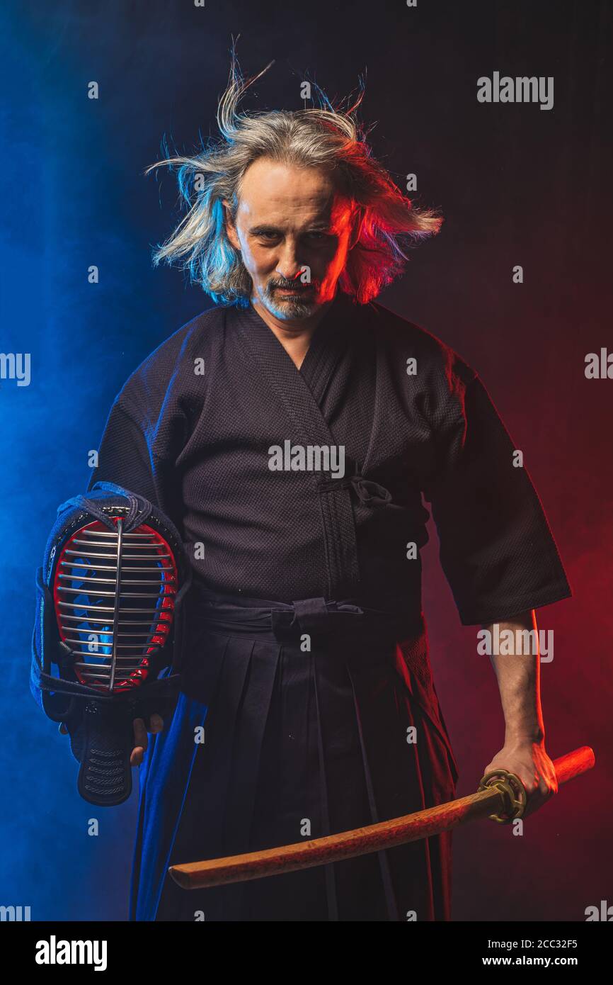 kendo combat warrior in traditional dress on smoky background, before ...