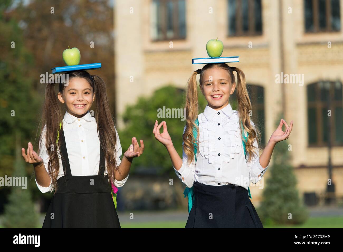 Find inner balance girls with books on heads, harmony concept Stock ...