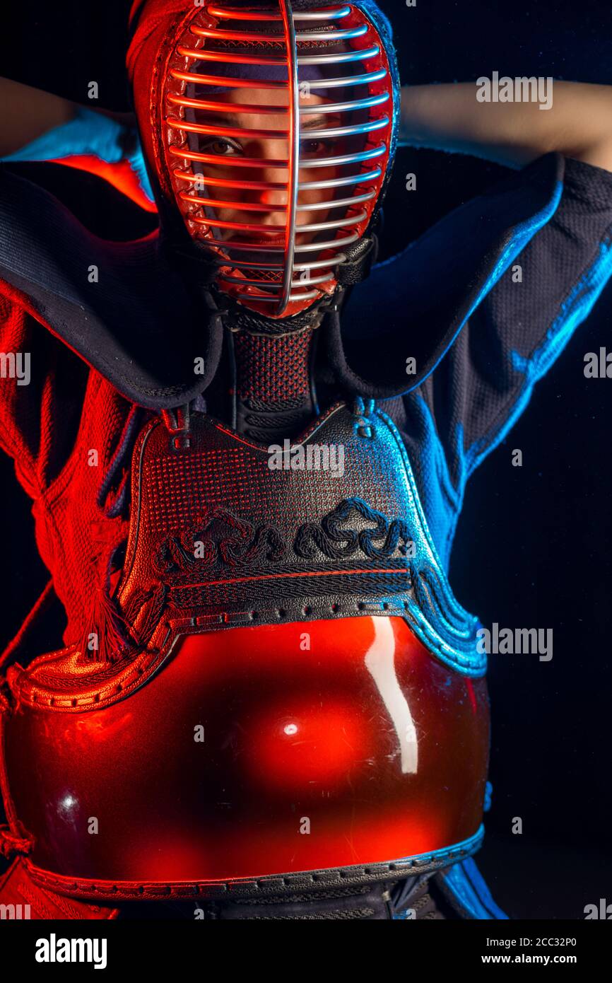 young caucasian female kendo fighter wearing mask, woman in kendo suit ...