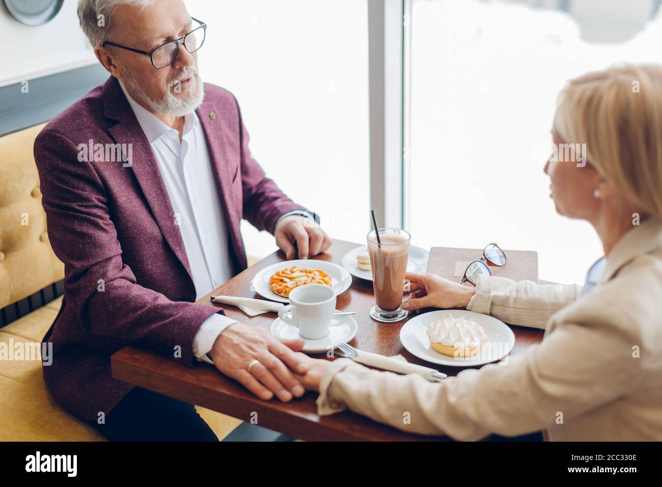 loving old couple having a chat in the coffee shop. close up photo ...